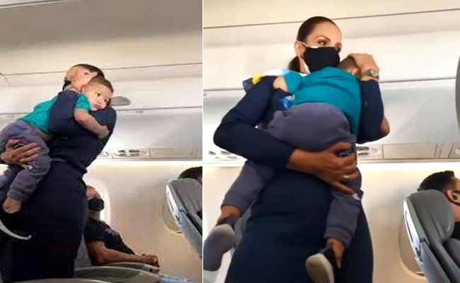 Flight Attendant Soothing an Inconsolable Child on a Flight, Video ...